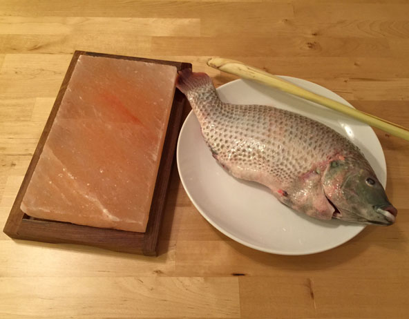 Delicious whole fish grilled on cooking salt plank